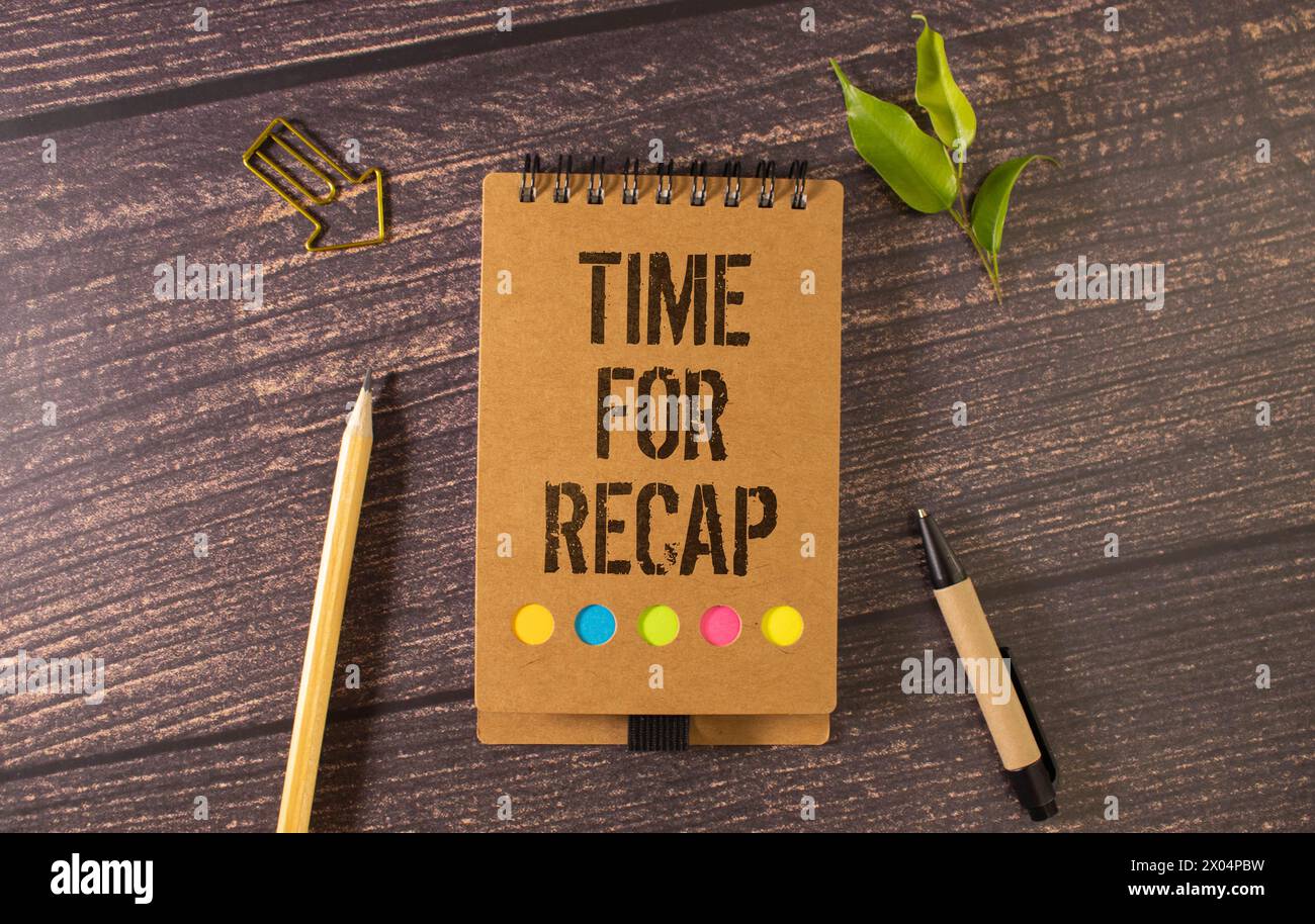 The text TIME FOR RECAP appearing on yellow paper behind torn color ...