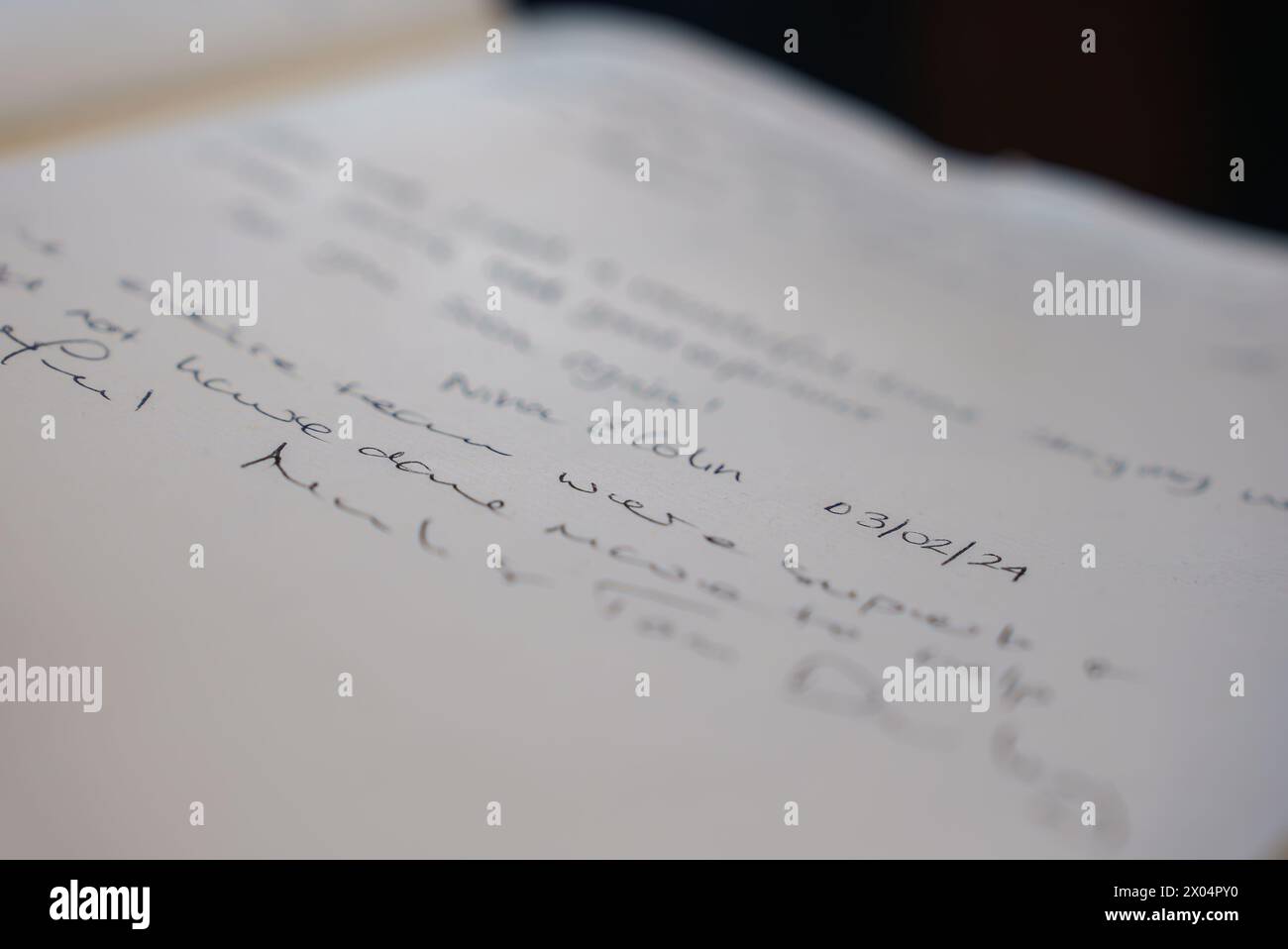 Handwritten note D30 or 12 or 21 in cursive on white paper, indoors ...