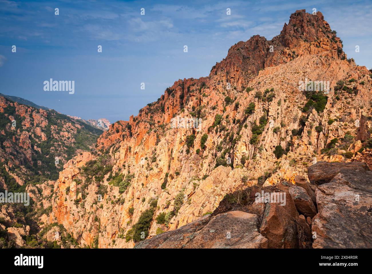 Red rocks of Calanques de Piana are under blue cloudy sky on a sunny ...