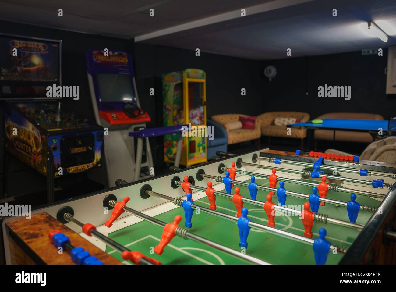Game Room with Foosball Table, Arcade Machines, and Couch Stock Photo ...