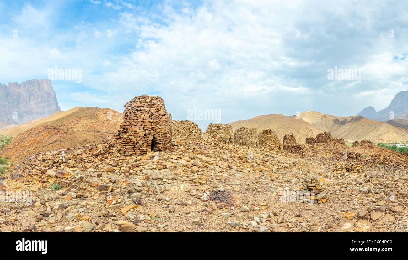 Group of ancient stone beehive tombs with Jebel Misht mountain in the ...