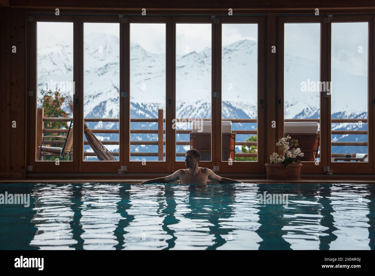 Serene swimming pool with mountain view in alpine setting Stock Photo ...