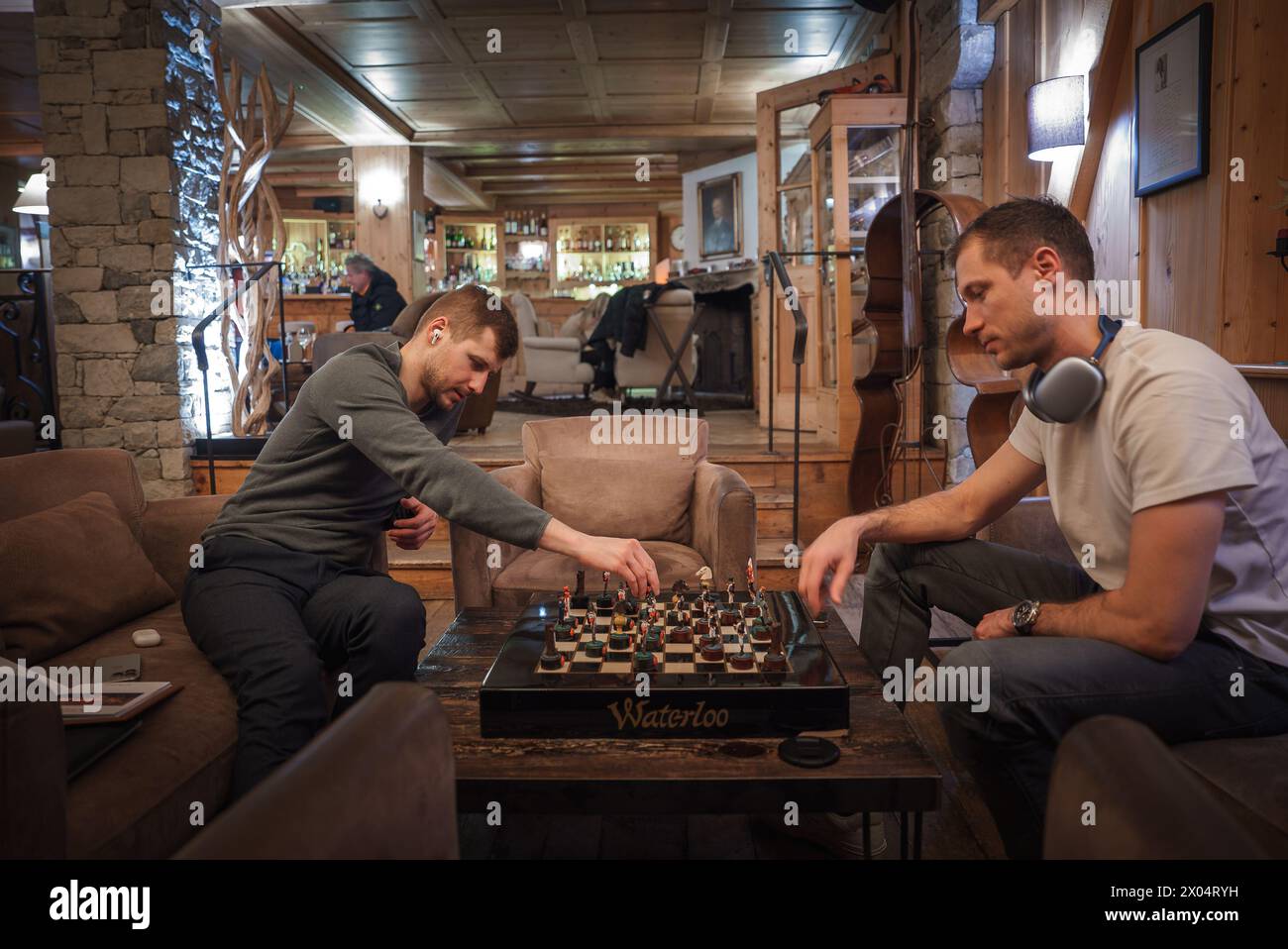 Men playing chess in a cozy, rustic room with unique set, Waterloo ...