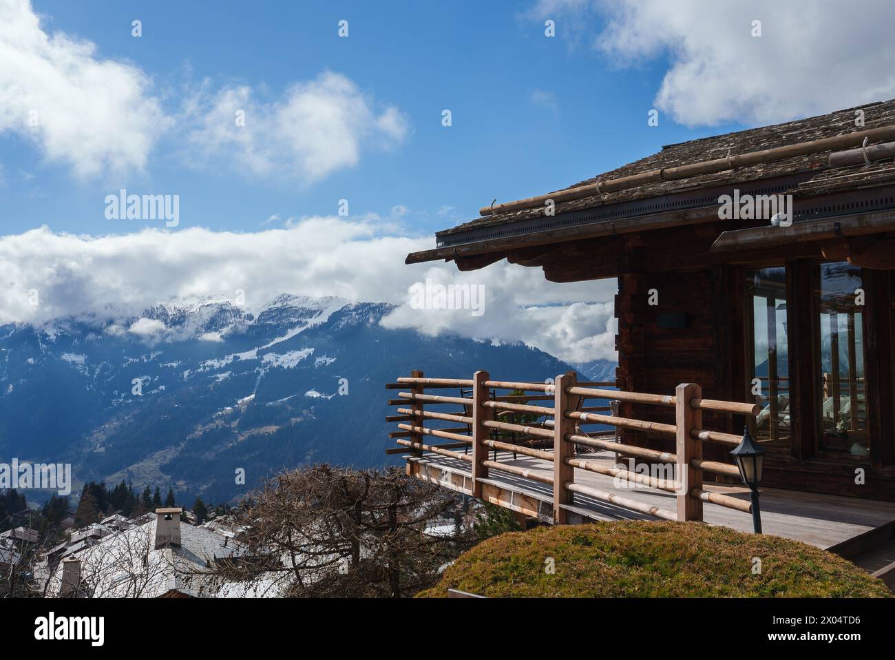 Alpine chalet with rustic balcony, mountain views, lantern light Stock ...