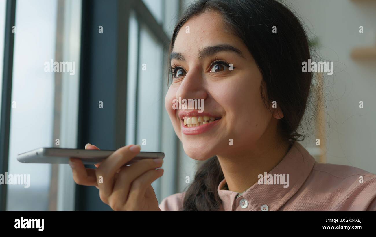 Happy cheerful Arabian Indian business girl talk mobile phone near ...