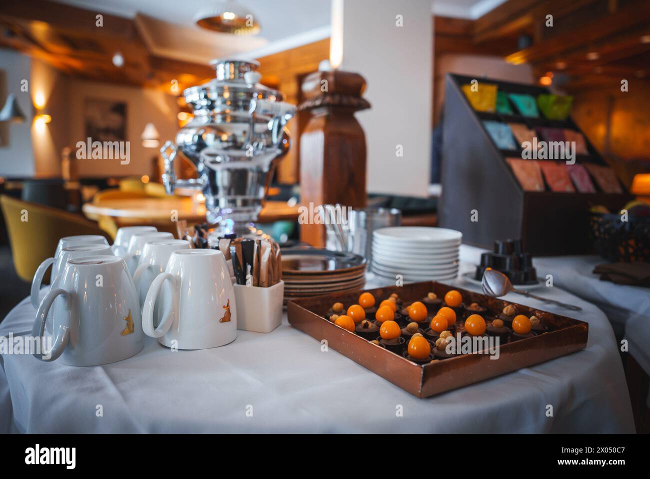 Elegant Buffet Setup with Dining Table, Beverage Dispenser, and Variety of Snacks Stock Photo ...