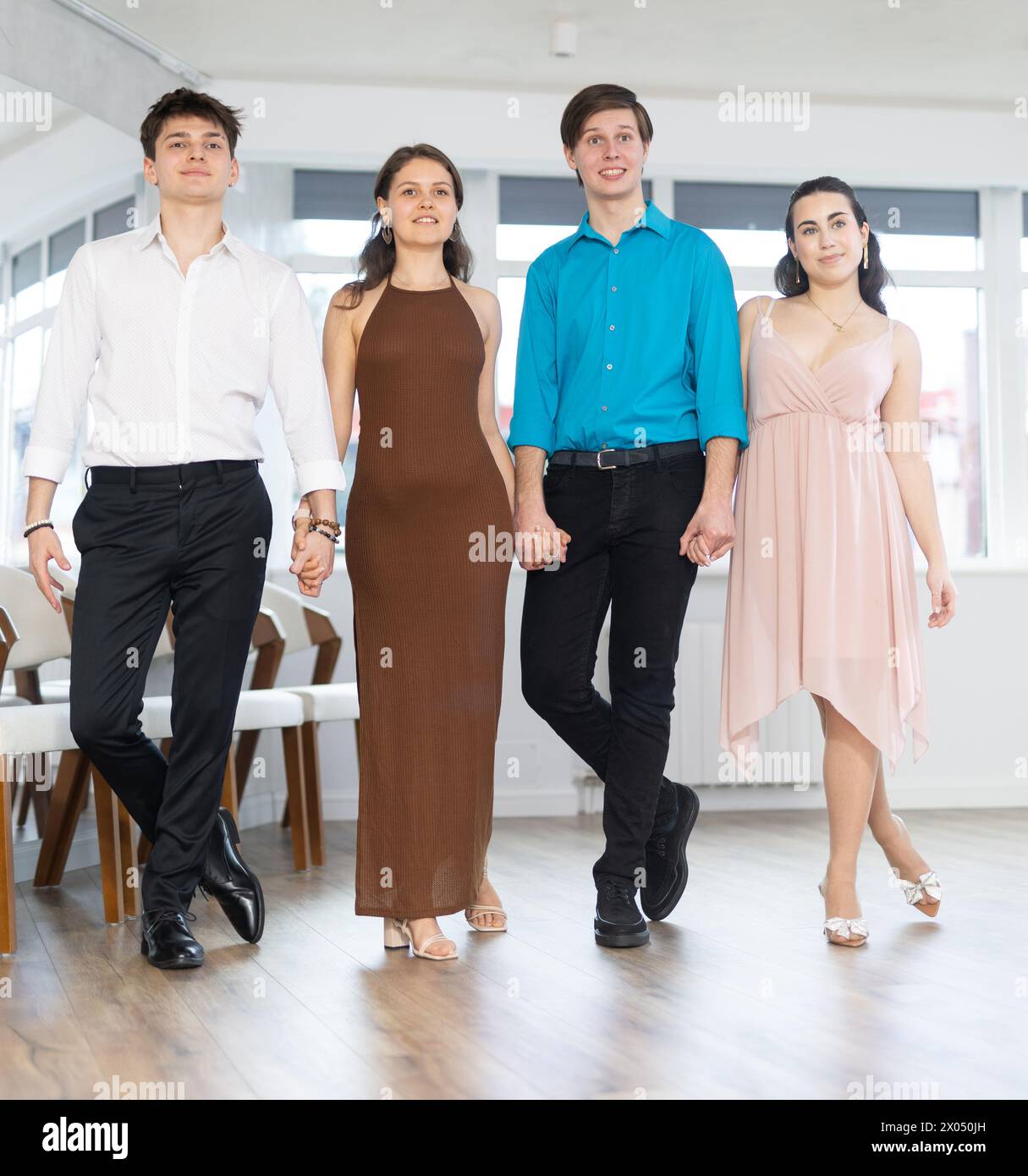 Girls and guy dancing folk dance in row in dance studio Stock Photo - Alamy