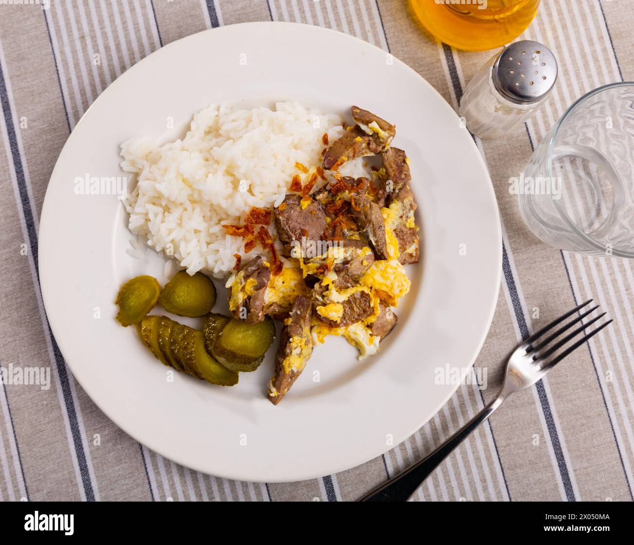 Omelet fried with rabbit liver served with rice and pickles Stock Photo ...