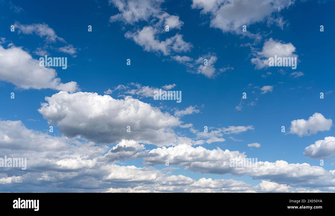 Beautiful vivid blue sky with white puffy clouds Stock Photo - Alamy