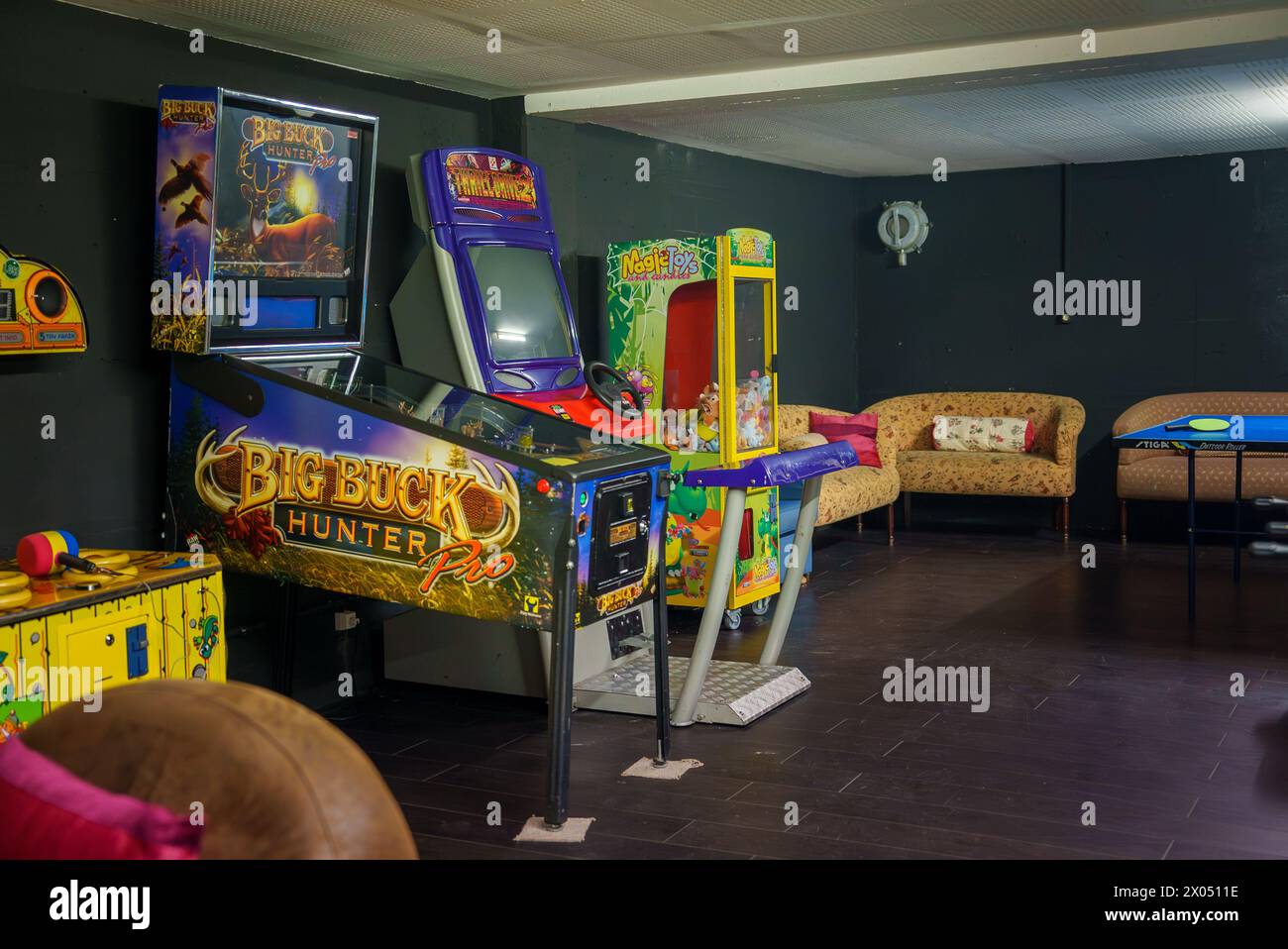 Arcade room with diverse gaming machines and seating Stock Photo - Alamy