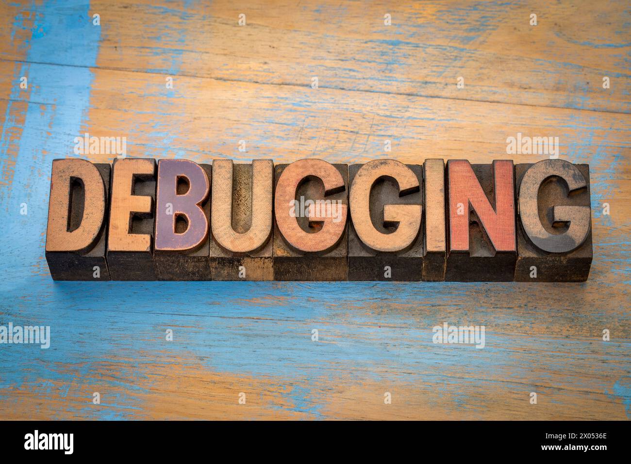 debugging - word abstract in vintage letterpress wood type against ...