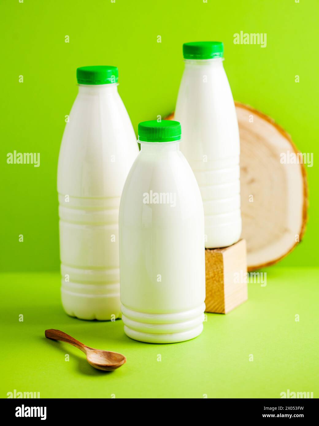 Triple set of dairy bottles with green caps, symbolizing freshness and ...