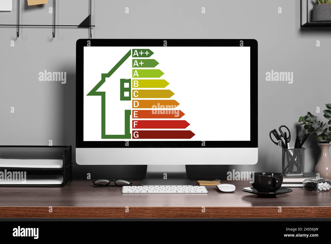 Energy efficiency rating on display. Workplace with modern computer ...