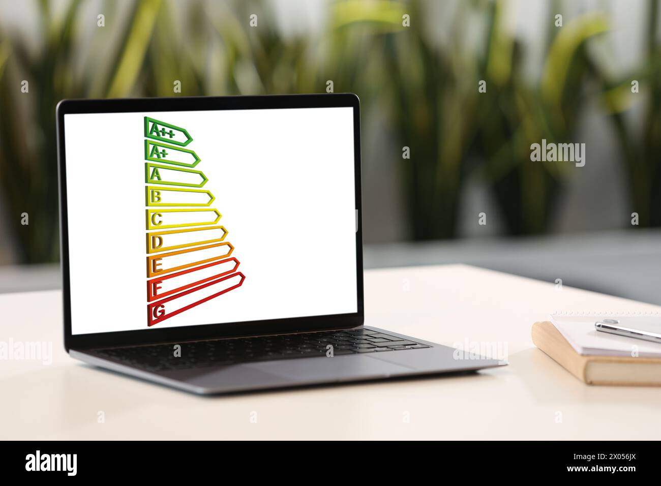 Energy efficiency rating on laptop display. workplace with modern ...