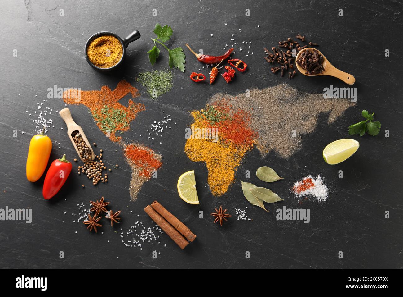 World map of different spices and products on dark textured table, flat ...