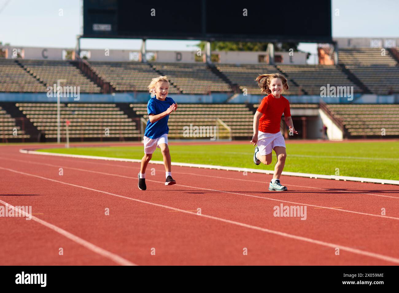 Child running in stadium. Kids run on outdoor track. Healthy sport ...