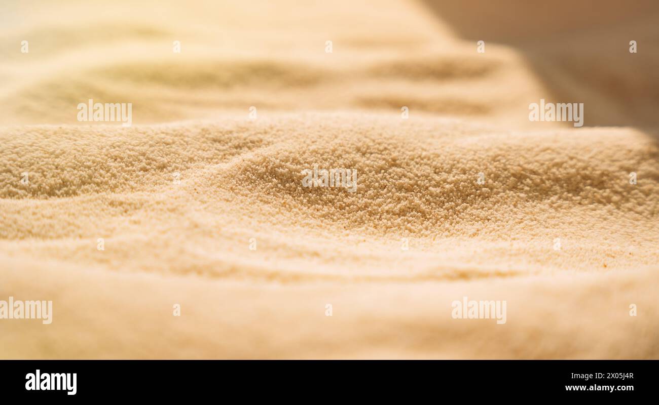 Yellow clean sand with wavy patterns under sunlight Stock Photo - Alamy