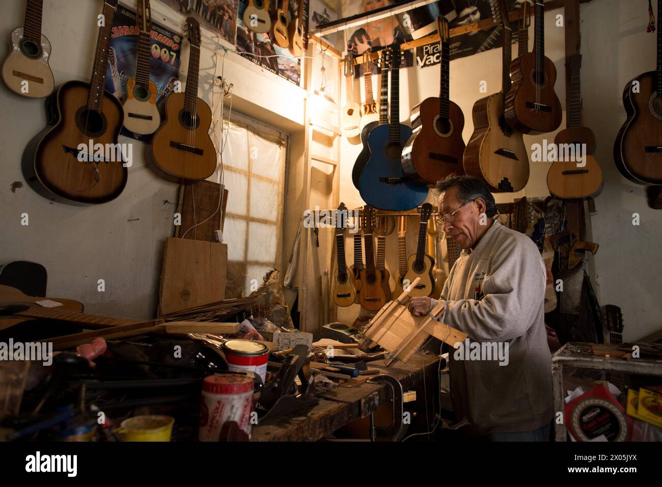 A craftsman builds and repairs string instruments like Guitars and ...