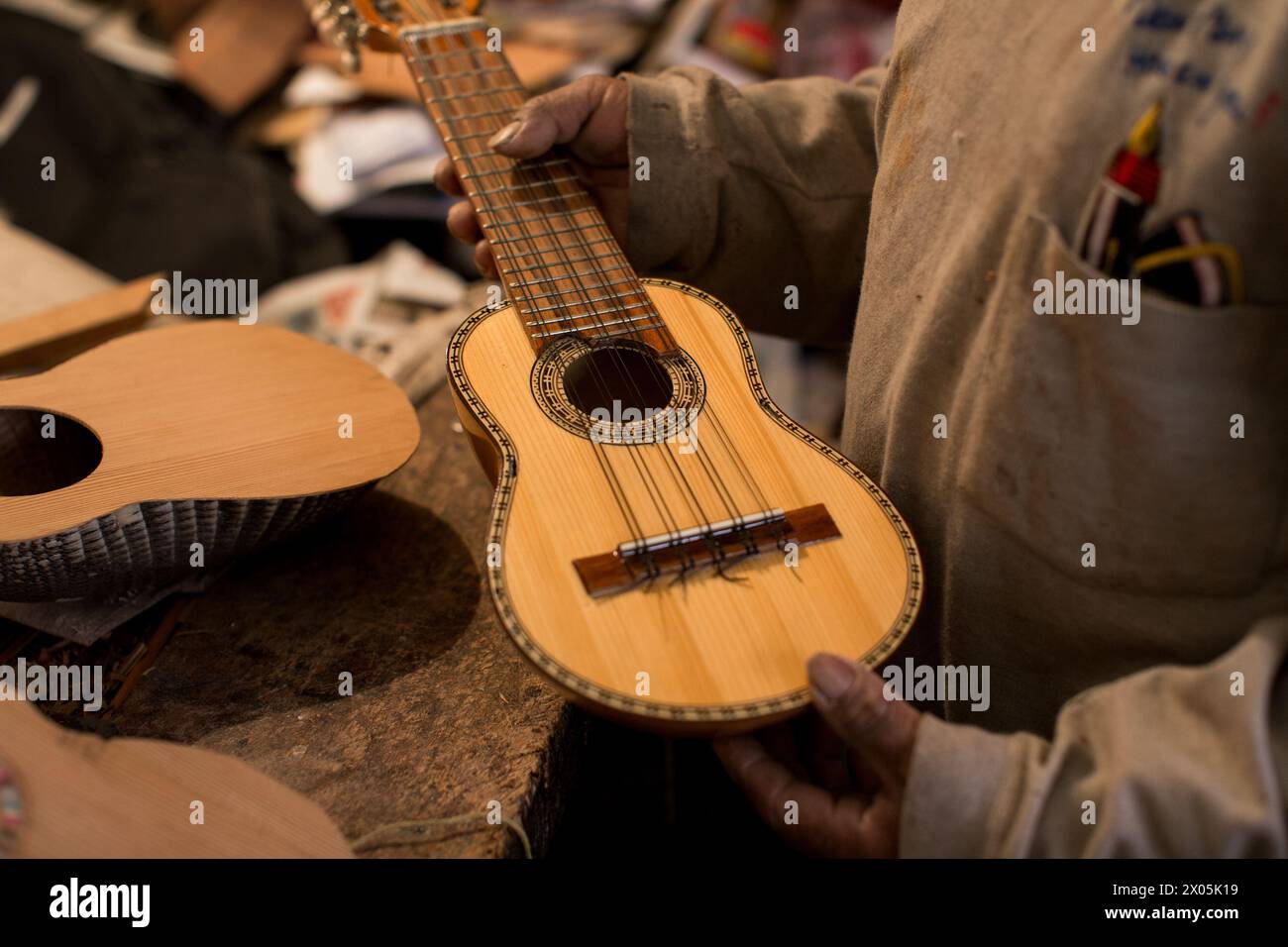 A craftsman builds and repairs string instruments like Guitars and ...