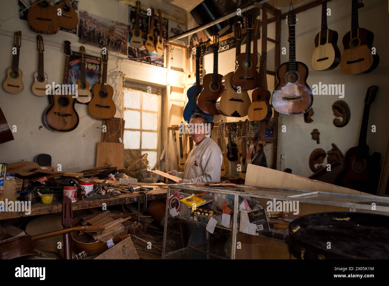 A craftsman builds and repairs string instruments like Guitars and ...