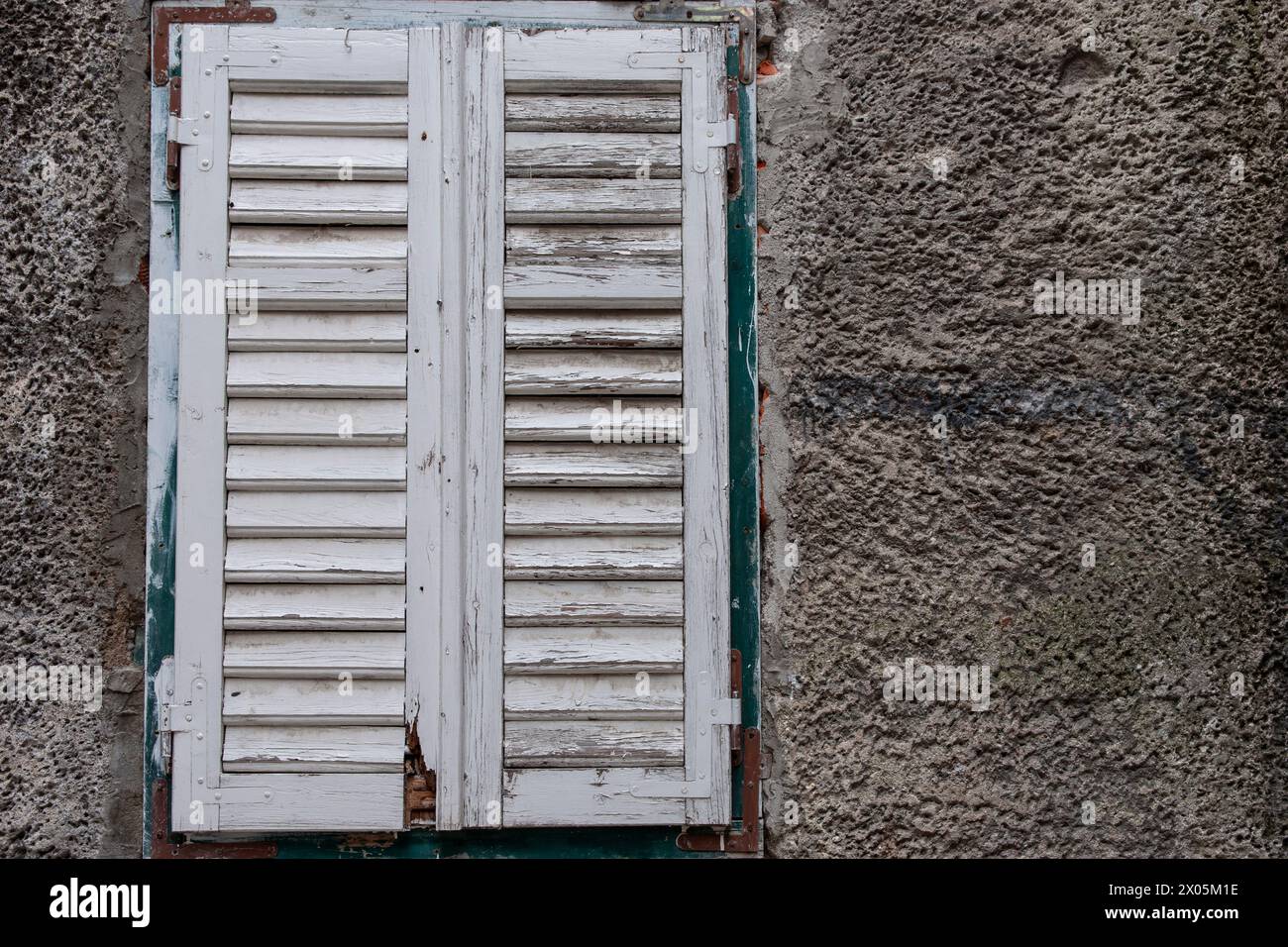 White shutter closed over old window in exterior wall Stock Photo - Alamy