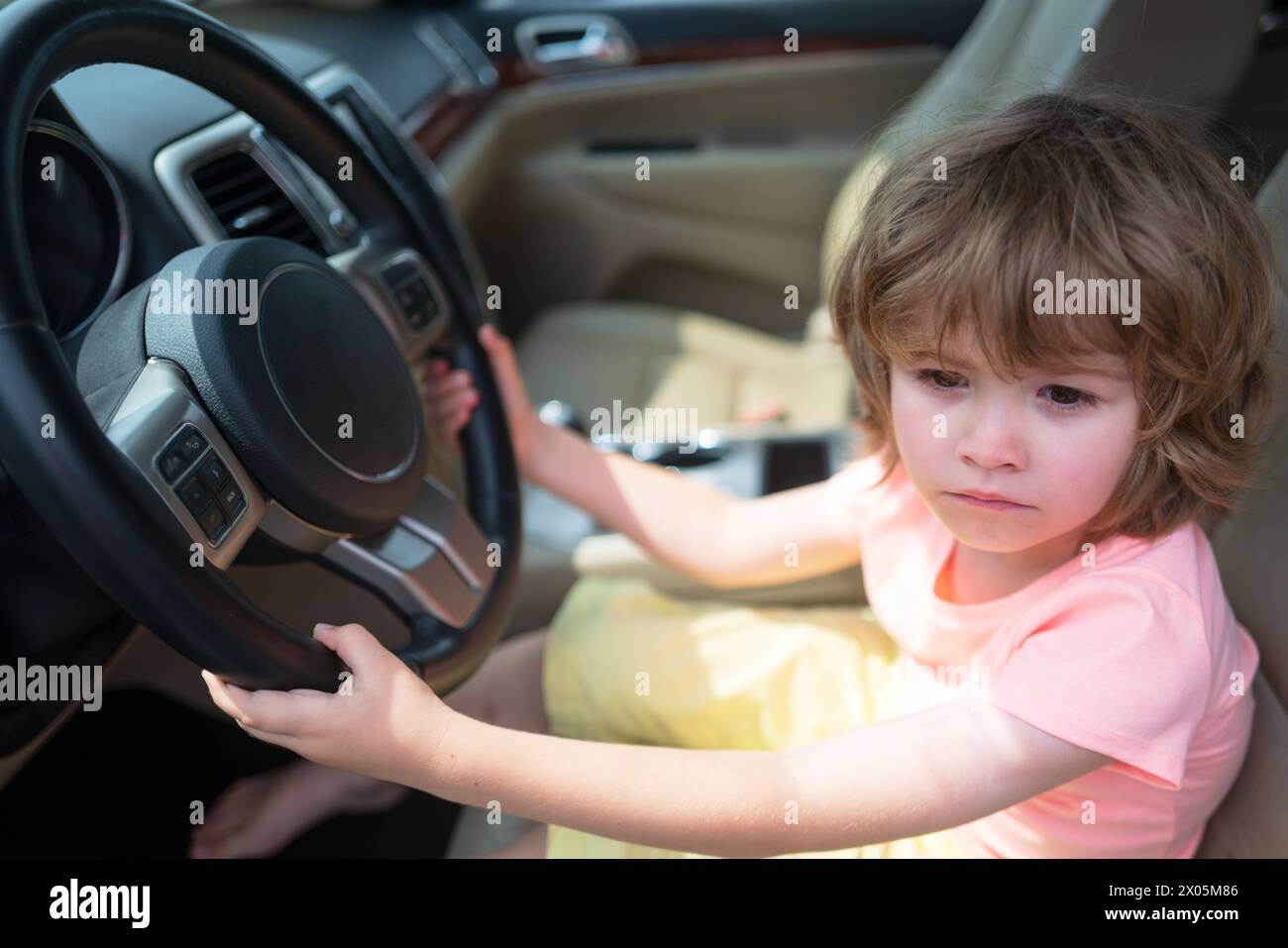 Kid Driver. Cute little boy pretending to drive. Kid in car with his ...