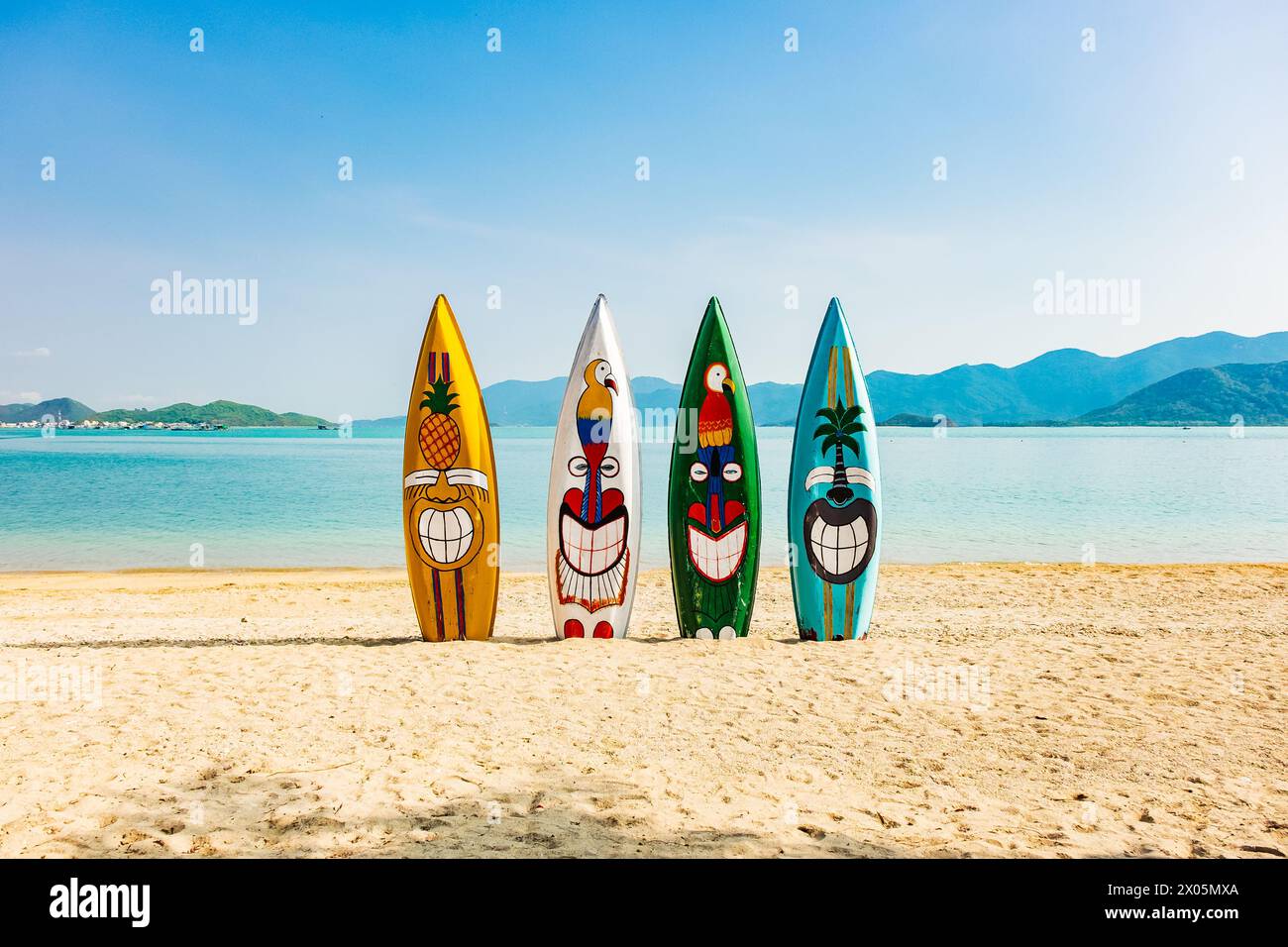 Surf board in the sand at the beach. Colorful surf board on the beach ...