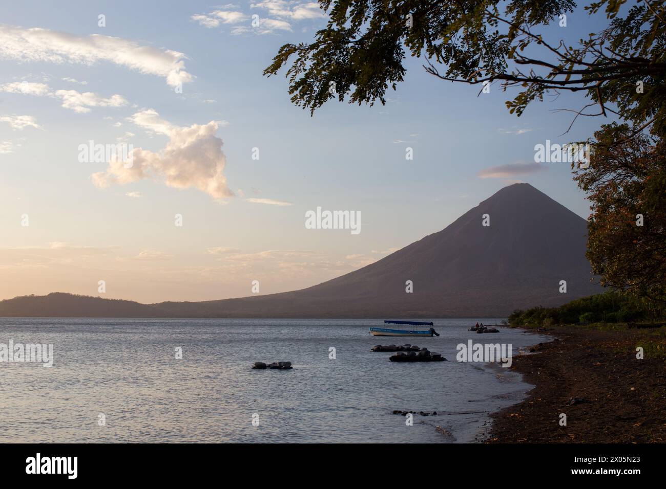 Sunset across Lake NIcaragua casts sunlight across the island of ...