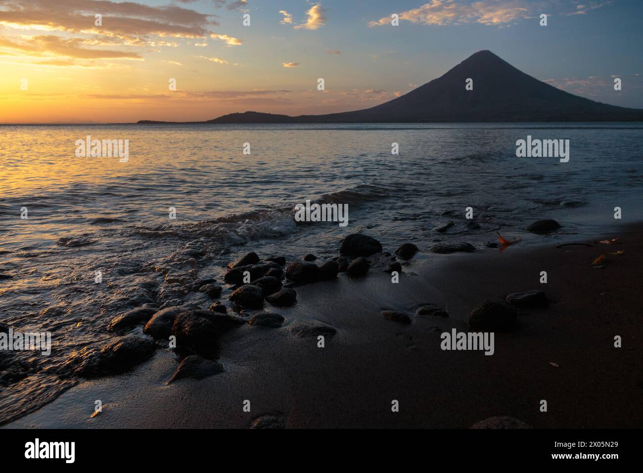 Sunset across Lake NIcaragua casts sunlight across the island of ...