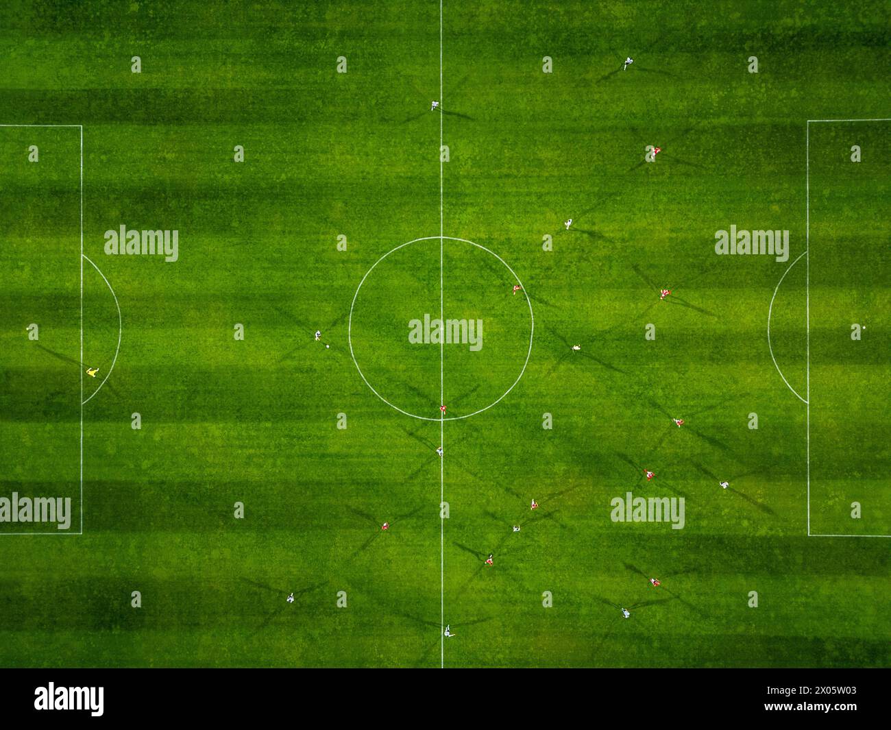 Aerial view of a soccer field in action, with players running, passing ...