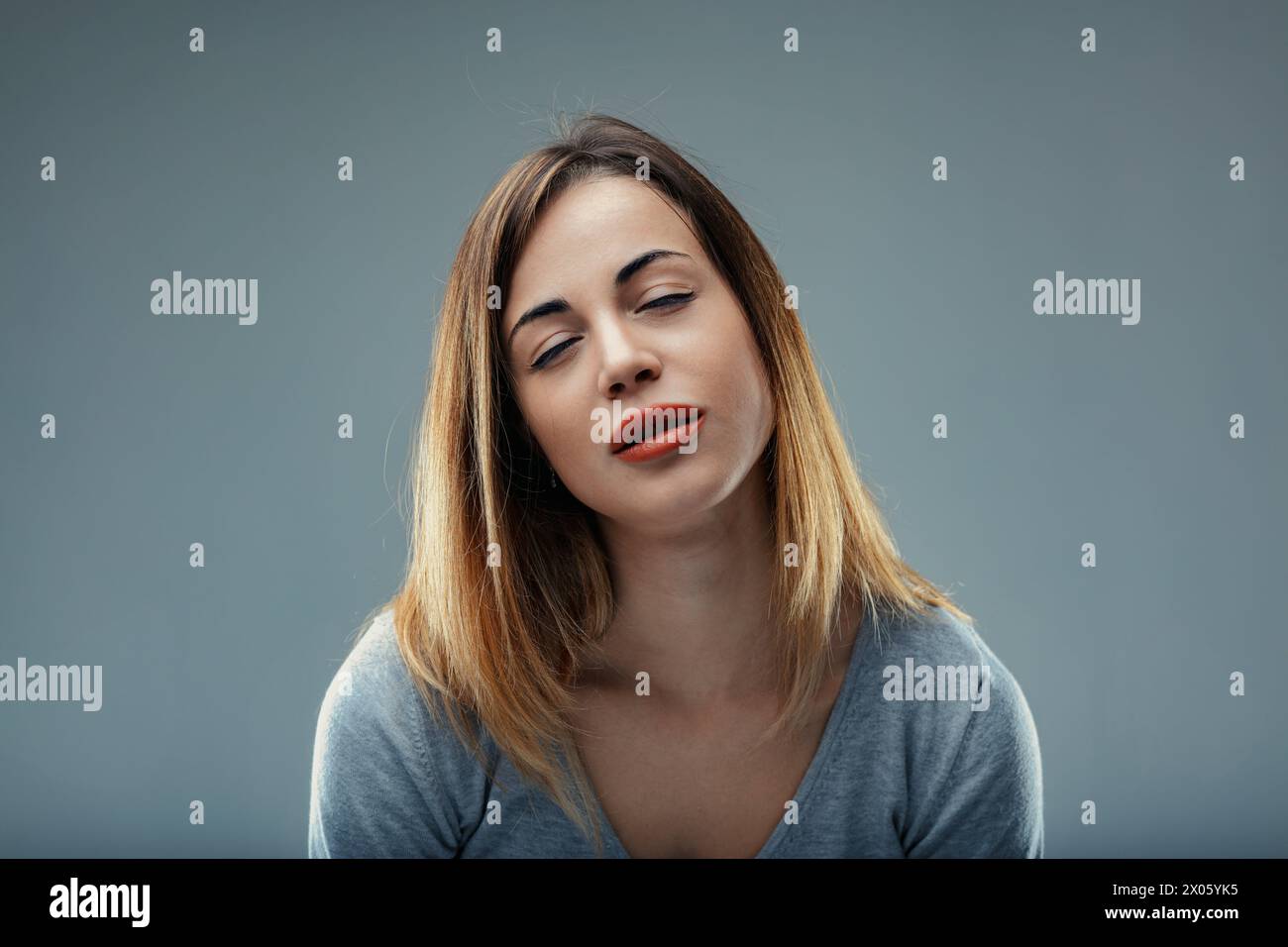 Fatigue etched on her face, she's seemingly fed up with the monotony ...