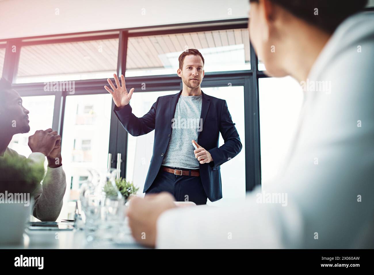 Man, meeting and whiteboard in office with talking for marketing career ...