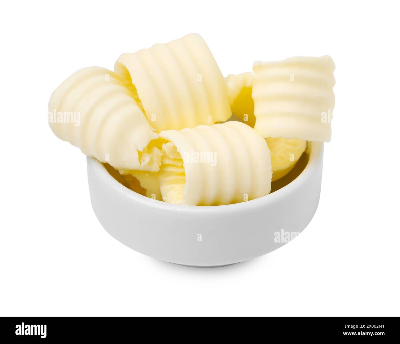 Tasty butter curls in bowl isolated on white Stock Photo - Alamy