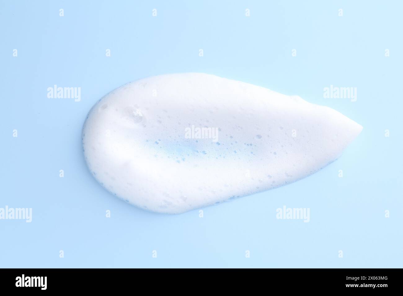 Sample of fluffy foam on light blue background, top view Stock Photo ...