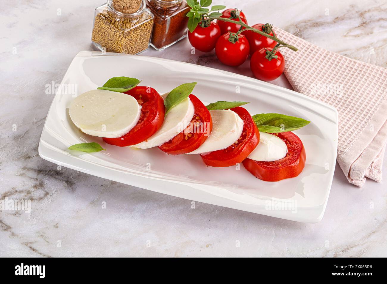 Italian caprese salad with mozzarella, tomato and basil Stock Photo - Alamy