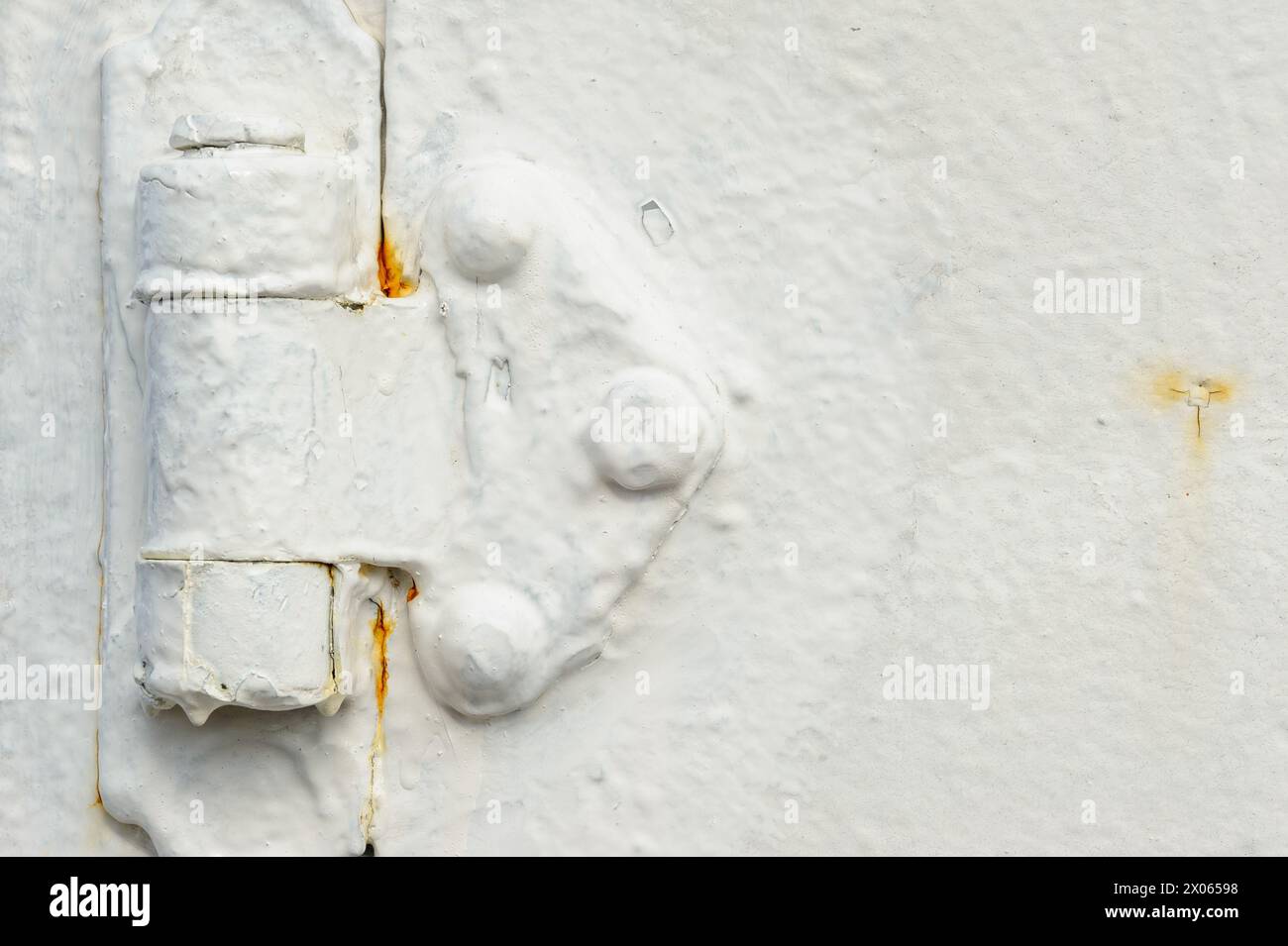 Peeling paint reveals rust on a weathered metal surface, illustrating ...