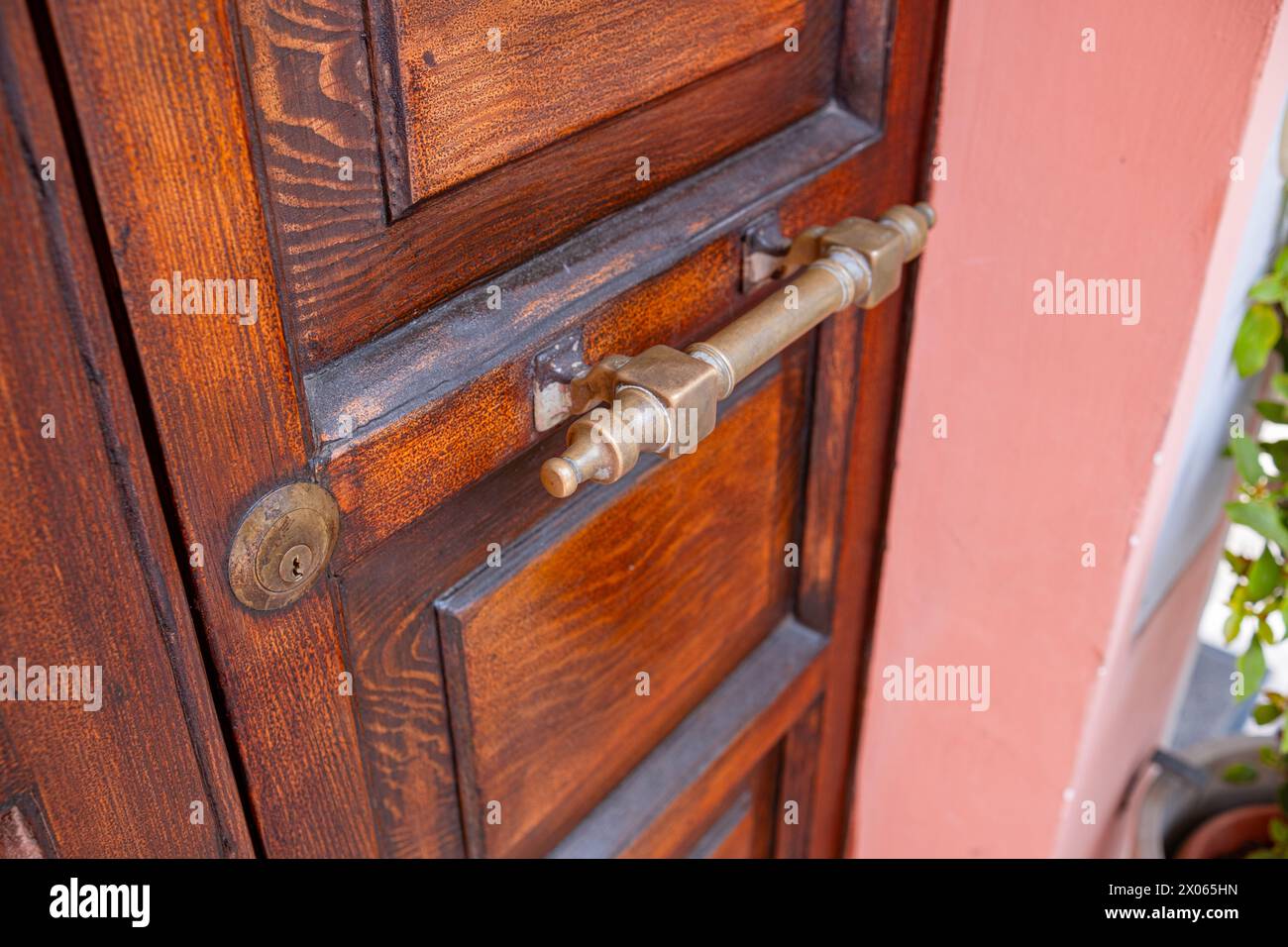 Antique wooden door with gilded handle. Metal door handle close-up ...