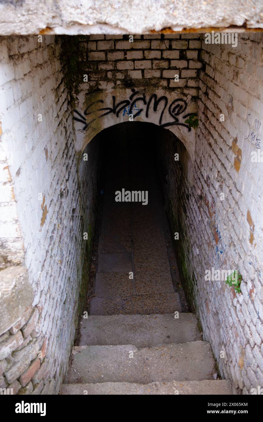 A terrible, dilapidated entrance to an underground passage running ...