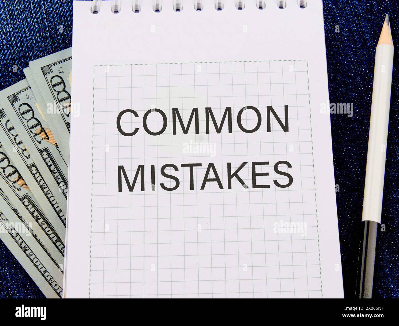 Common mistakes, text on a notepad against the background of money ...