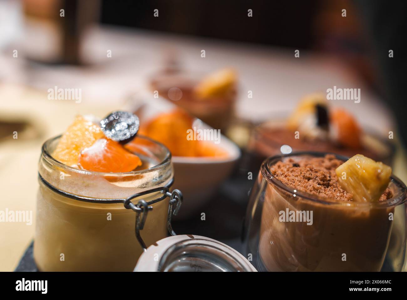 Desserts in Glass Jars with Orange Fruit, Cafe Setting Stock Photo - Alamy