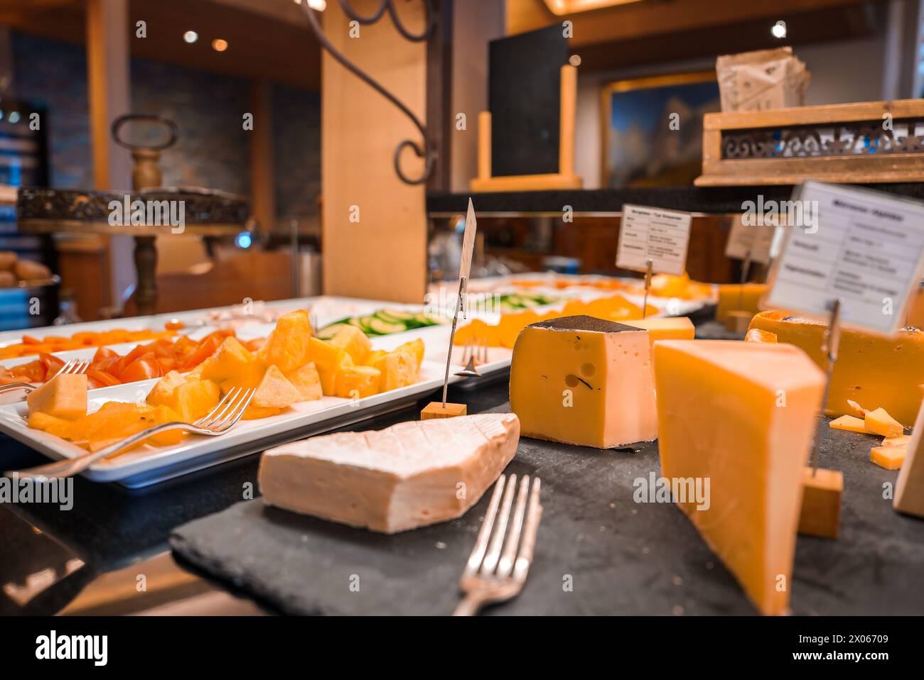 Cheese Buffet Table with Various Gourmet Selections, Serving Forks, and ...