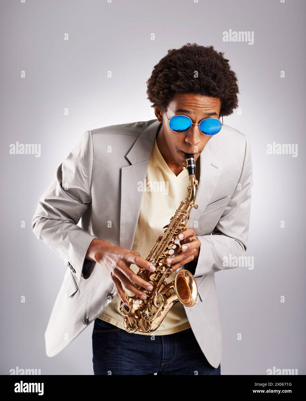Happy, black man and music, playing the saxophone with casual suit and ...