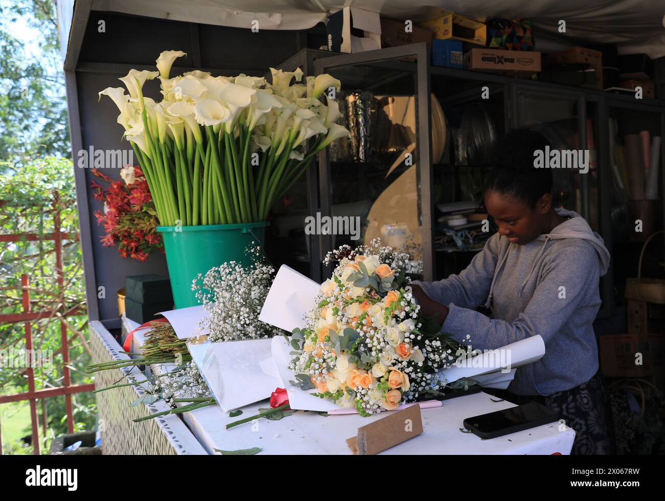 Kigali, Rwanda. 9th Apr, 2024. A vendor prepares bouquets at a flower ...