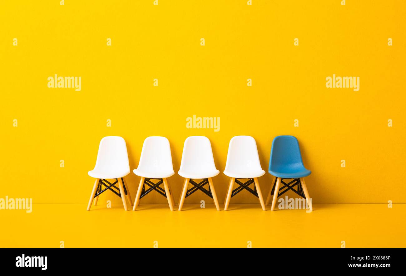 Blue chair standing out from the crowd Stock Photo - Alamy
