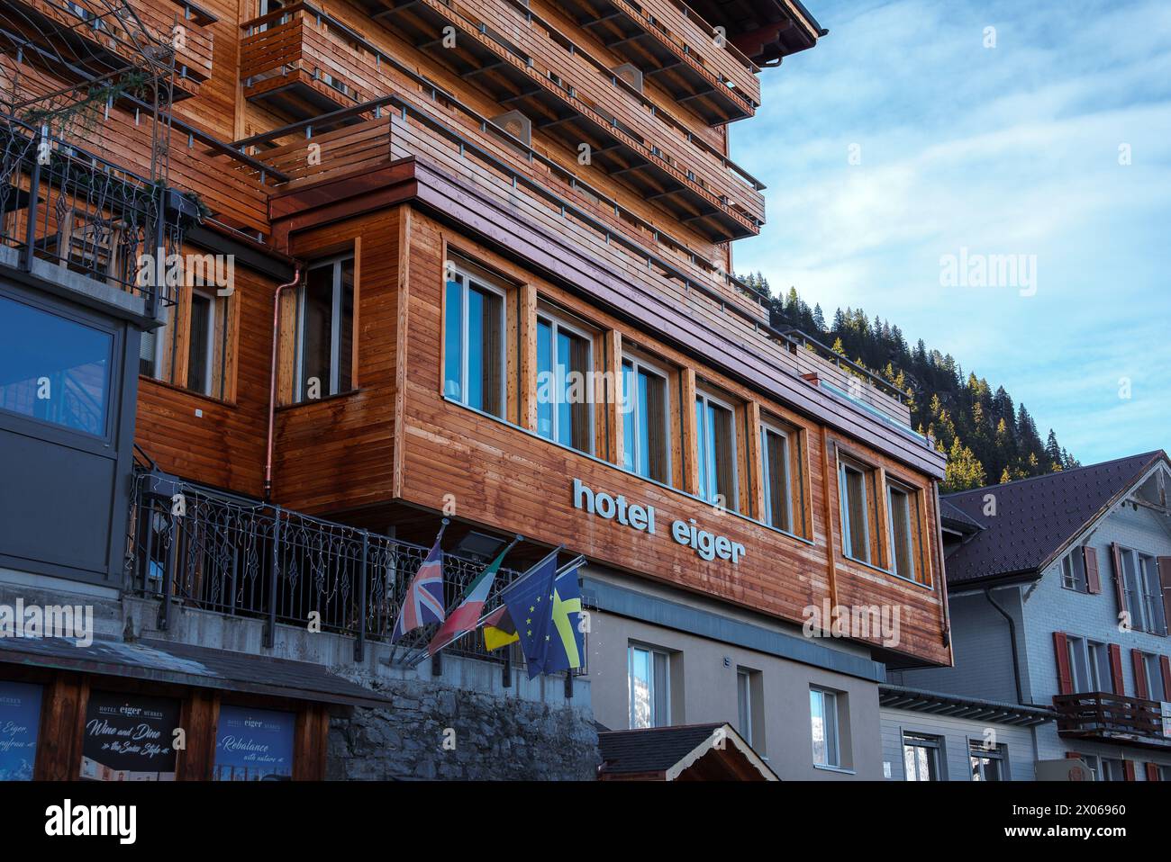 Hotel Eiger Modern alpine building with international flags in mountain ...