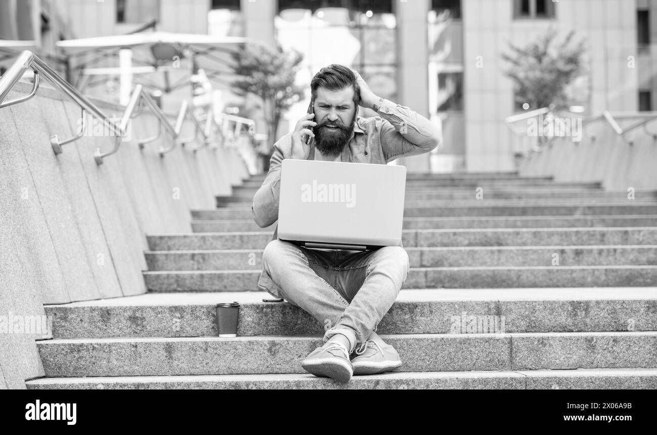 puzzled freelancer man has communication on pc outdoor. communication ...