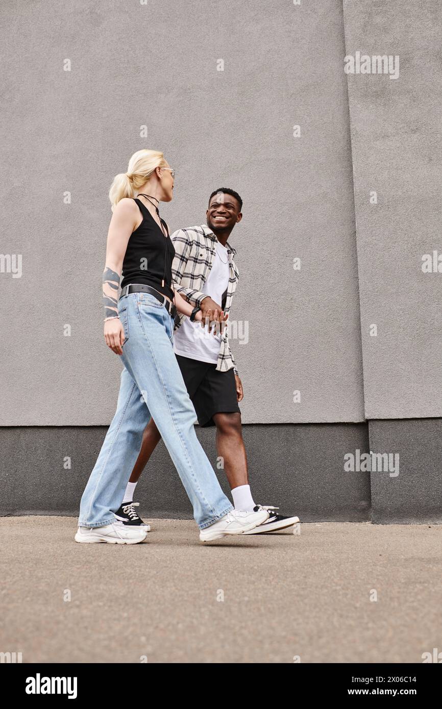 Young black couple walking down hi-res stock photography and images - Alamy