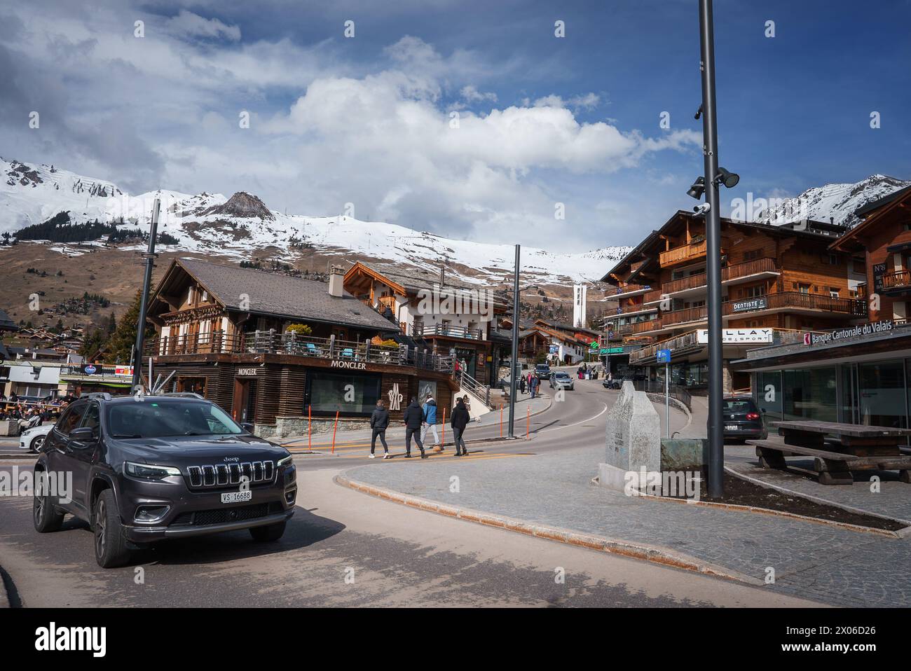 Alpine Chalet Street Scene with Jeep and Pedestrians Stock Photo - Alamy