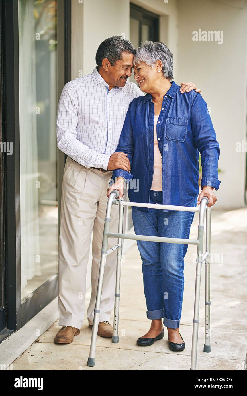 Couple, happy man and elderly woman with walker in backyard for care ...