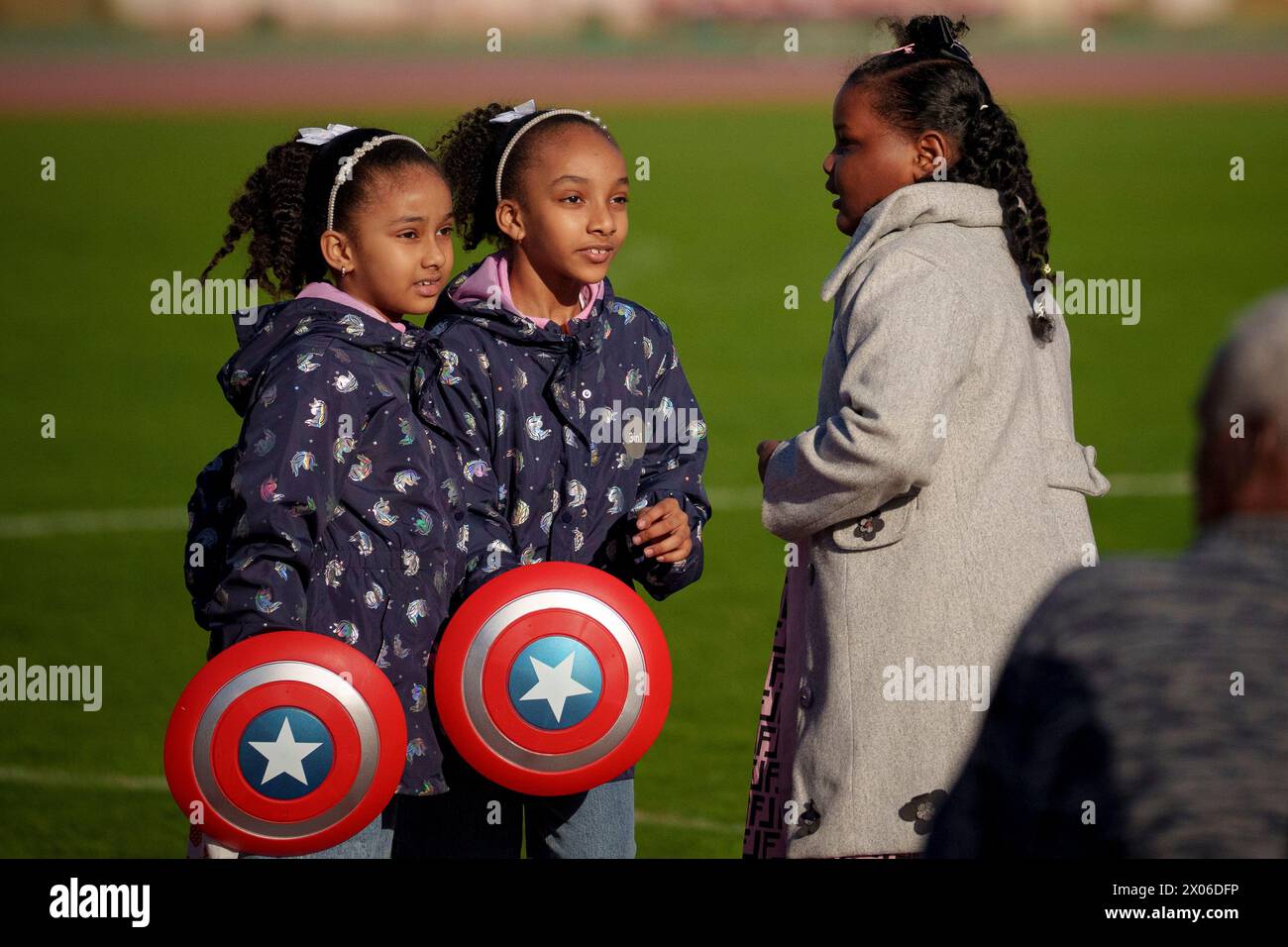 Two little girls hold toy shields at the end of Eid al-Fitr prayers in ...